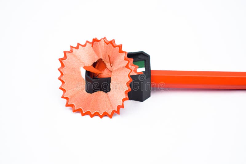 Sharpening a Orange Color Wood Pencil Crayon with a Black Color Plastic ...