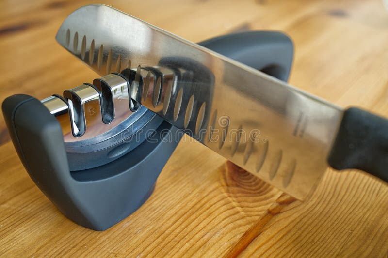 Sharpening a Santoku Kitchen Knife, Using a Domestic Sharpener. Stock ...
