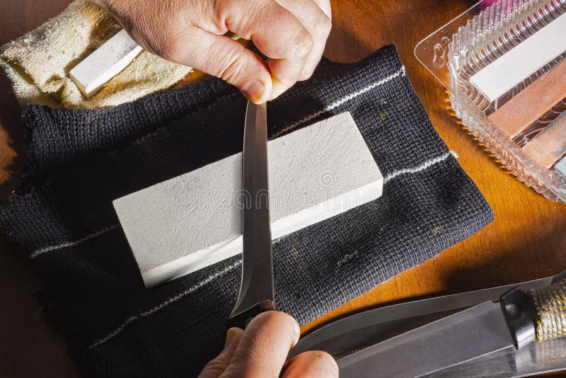 Sharpening of Steel Knives, on an Abrasive Stone Stock Photo - Image of ...