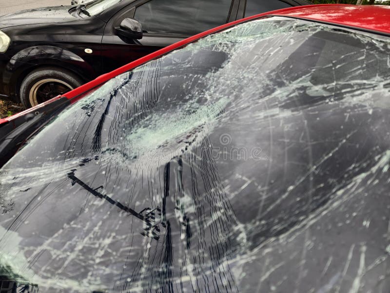 Shattered and Broken Windshield on a Bright Red Car Showcasing the ...