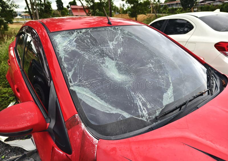 Shattered and Broken Windshield on a Bright Red Car Showcasing the ...