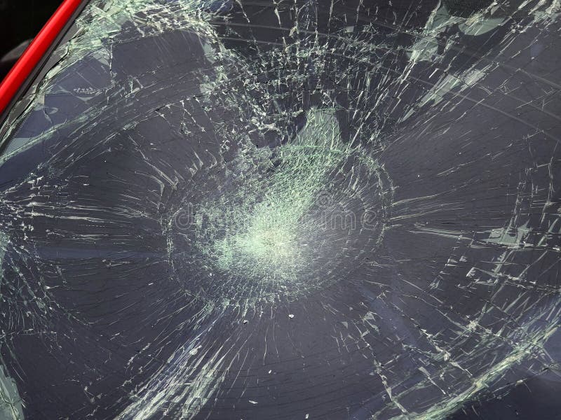 Shattered and Broken Windshield on a Bright Red Car Showcasing the ...