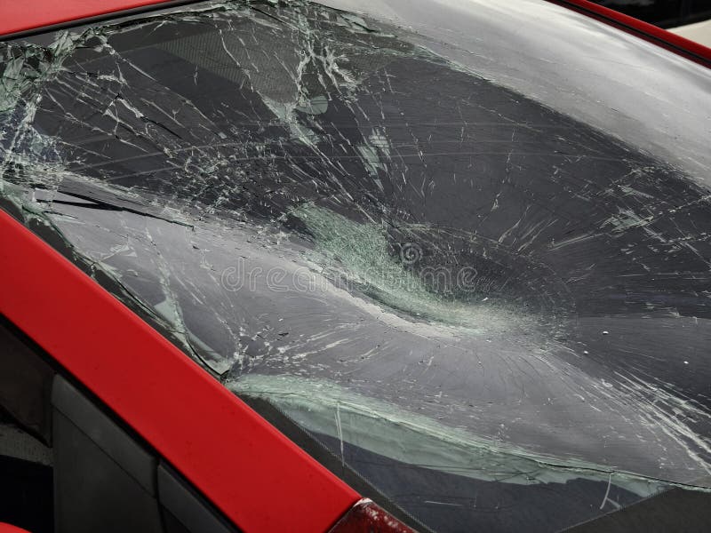 Shattered and Broken Windshield on a Bright Red Car Showcasing the ...