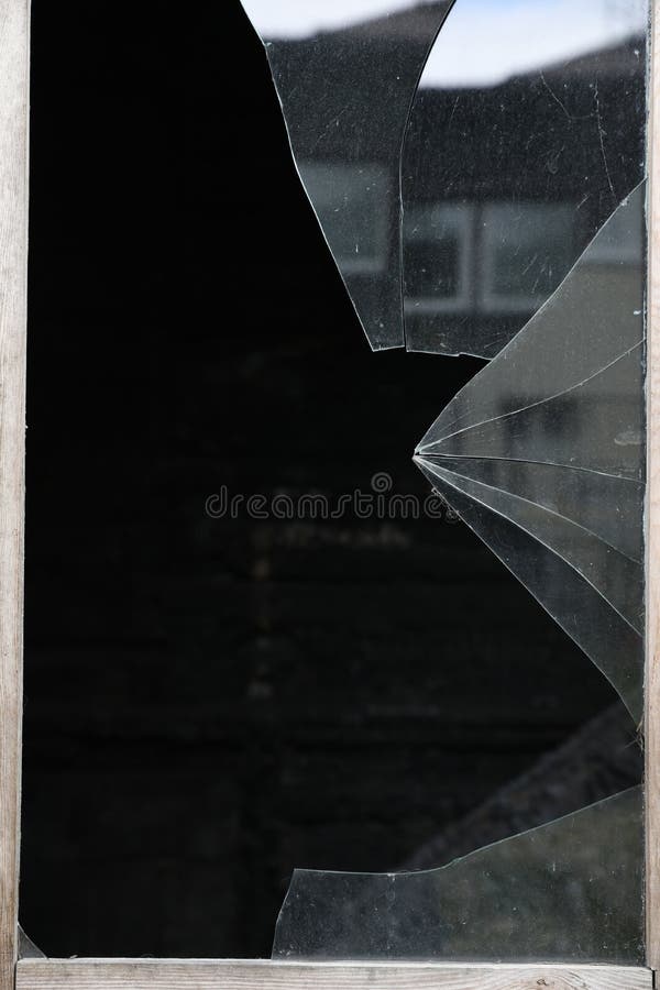 Broken Glass with Sharp Pieces Over Dark Grey Background. Destruction ...