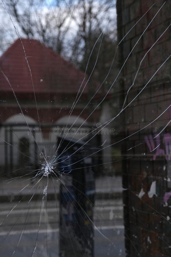 A Shattered Glass Window with Intricate Cracks Creating a Dramatic ...