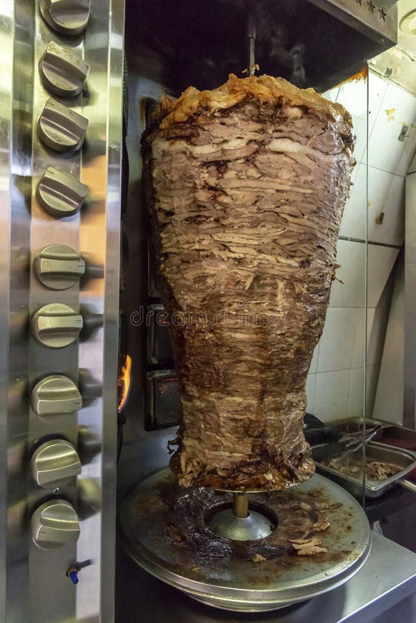 A Rotating Spit Roast of Meat Over Hot Coals. Grill Meat Dish, Roasted ...