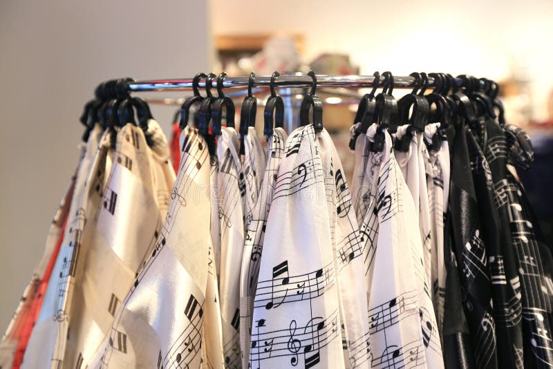 Shawls with Musical Notes Hanging on Hooks Stock Photo - Image of ...