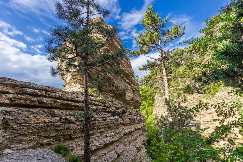 Sheer Cliffs of Layered Rocks Close-up on Clear Day, Clouds on Sky ...