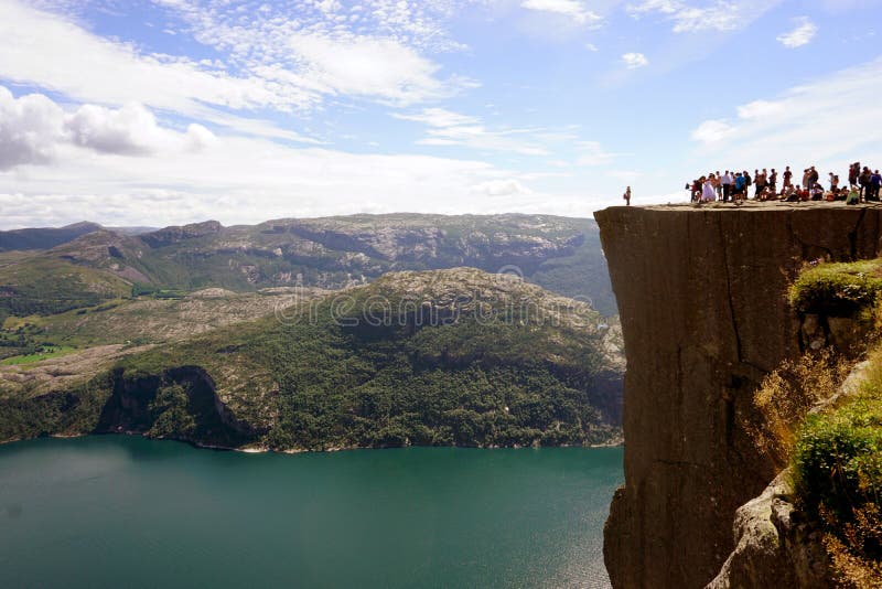 Sheer Rock with Tourists Surrounded by Lake and Sky Stock Photo - Image ...