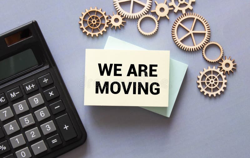 A Sheet on a Black Background with Text we RE MOVING. Business Concept ...