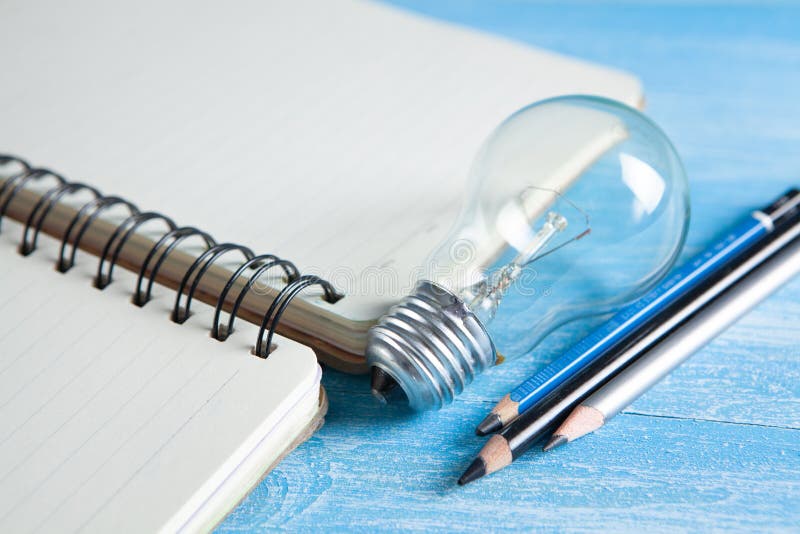 Sheet with a Notebook with Pens and a Light Bulb on the Table Lk. New ...