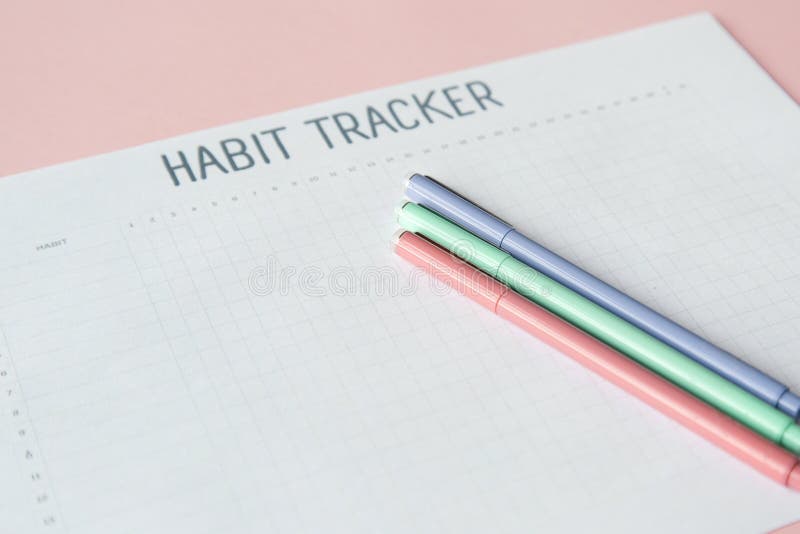 Sheet of Paper with Habit Tracker and Multi-colored Pens on a Pink ...