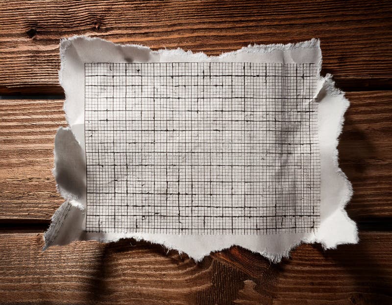 A Sheet of Torn Graph Paper with Precise Geometric Lines Placed Atop a ...