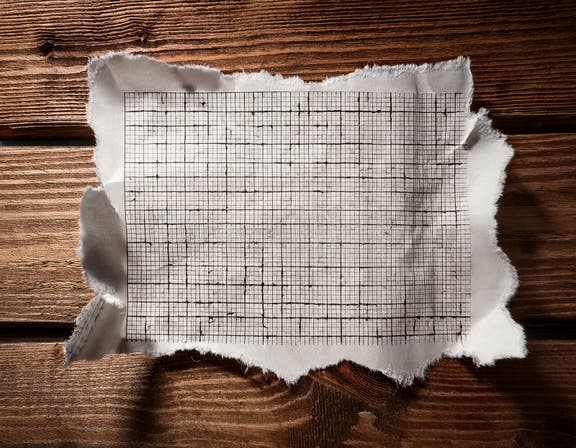 A Sheet of Torn Graph Paper with Precise Geometric Lines Placed Atop a ...