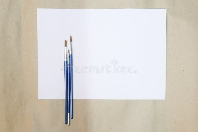 Sheet of White Paper and Artistic Brushes on a Crafting Background ...