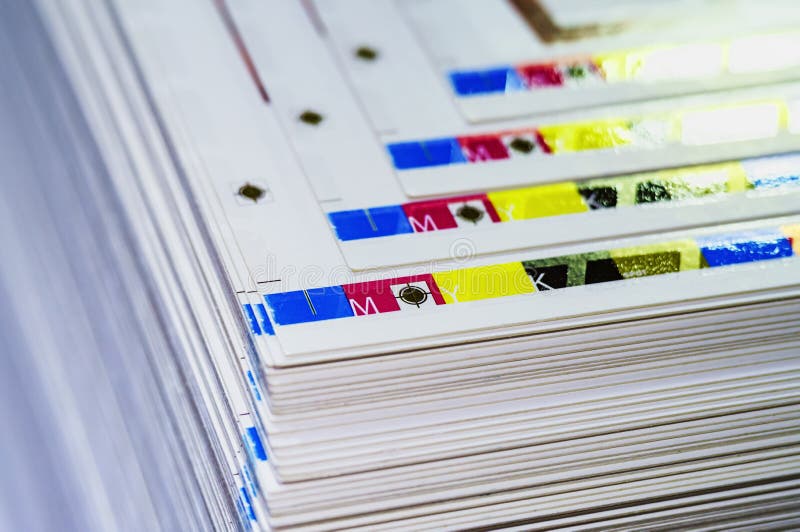 Sheets of Printed Products. Offset Printing. CMYK Press. Paper at the ...