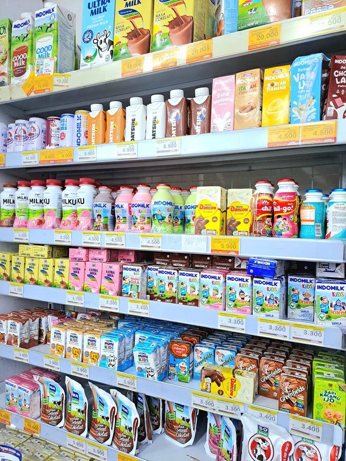 A Shelf Containing Various Kinds of Packaged Milk in a Supermarket ...