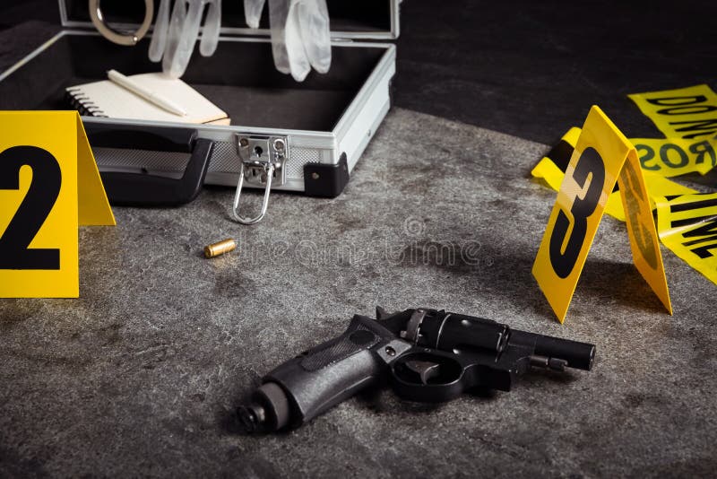 Shell Casing, Gun and Crime Scene Marker on Grey Stone Table Stock ...