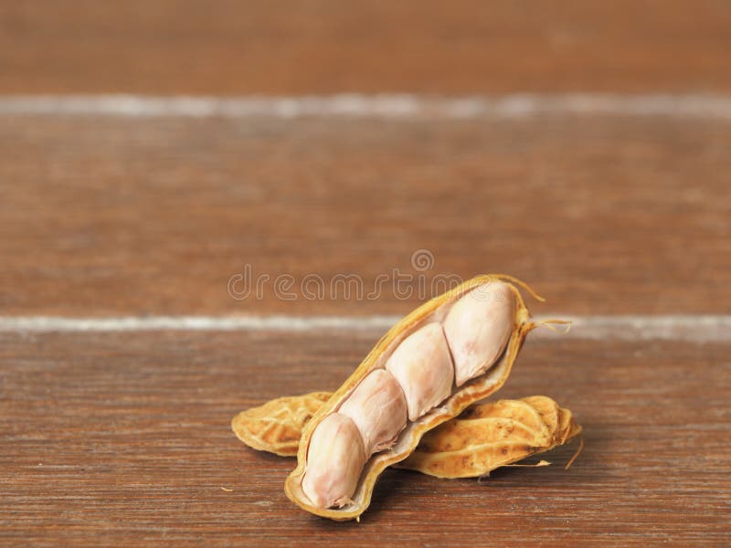 Shell Cracked Steamed Peanut Pile on Wooden Plank Table Top,Selective ...
