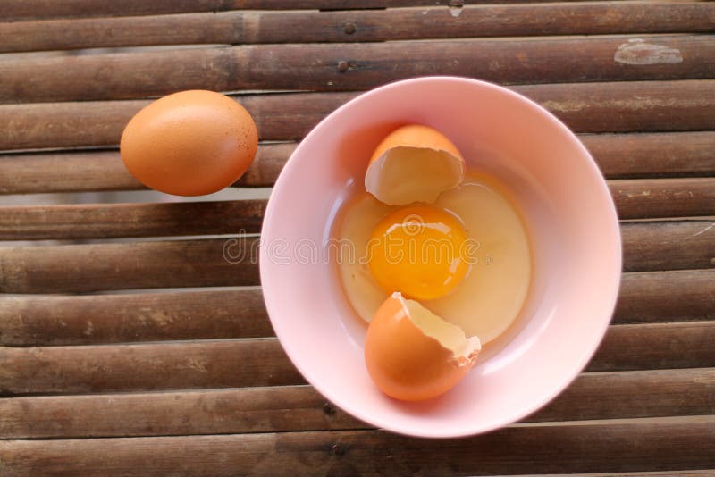 Shell with Egg and Open Eggs in a Pink Bowl on Bamboo Battens. Top View ...