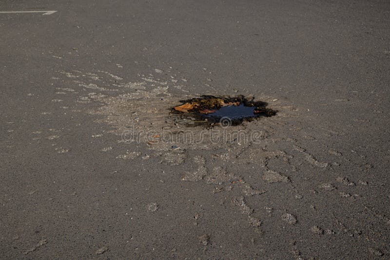 A shell hole in the road editorial stock image. Image of danger - 295177969