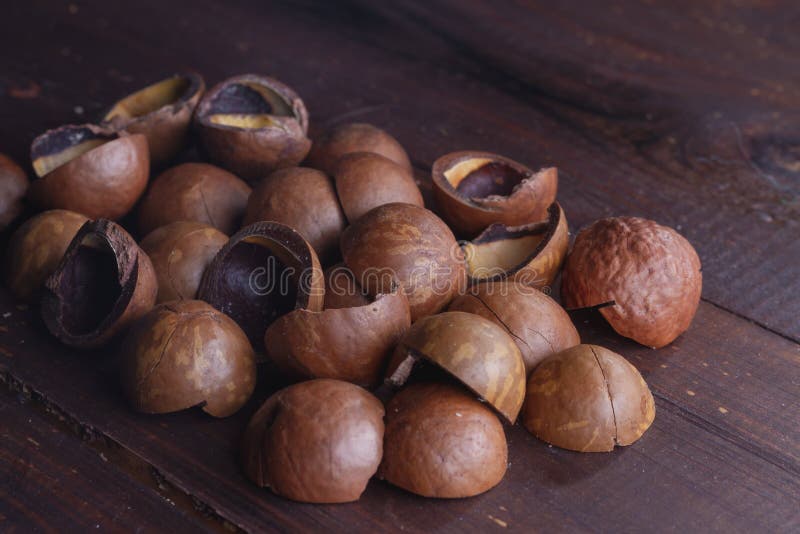 Macadamia Nuts on a Brown Wooden Table. Special Metal Key for Opening ...