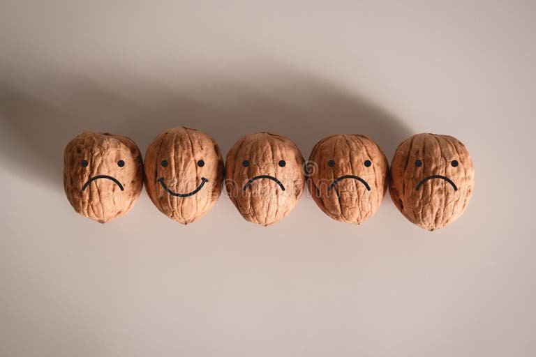 Shelled Walnuts with Stylized Faces of Smiling and Grumpy Faces on it ...