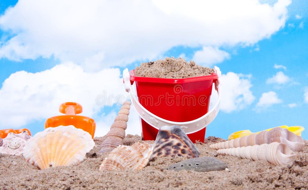 Shells and Plastic Beach Toys Stock Photo - Image of clouds, sieve ...