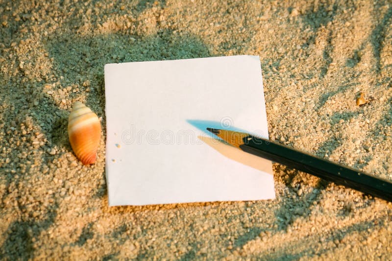 Background of Shells in the Sand with a Piece of Paper and a Pencil ...