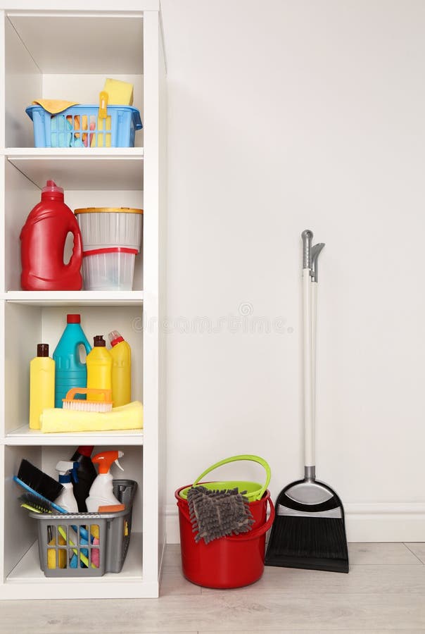 Shelving Unit with Detergents and Cleaning Tools Near White Wall ...