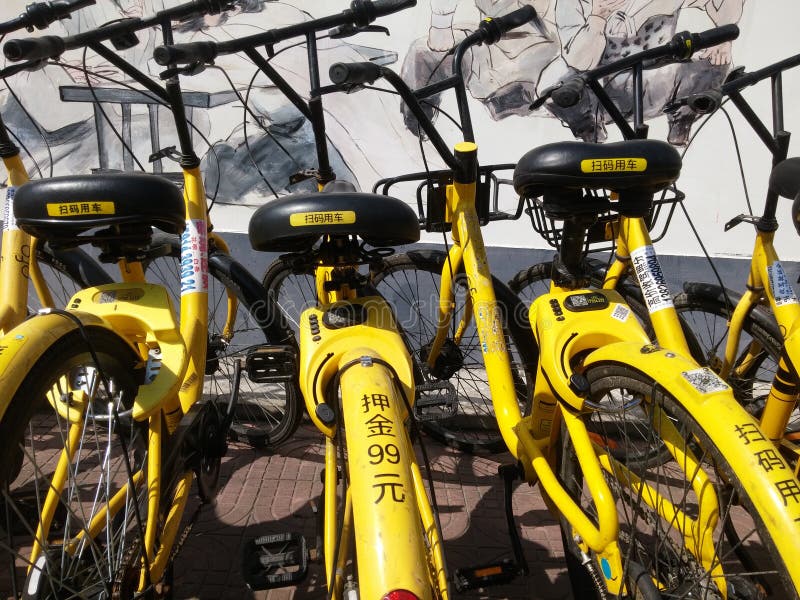 Shenzhen, China: a Row of Shared Bicycles Parked on the Sidewalk ... Shenzhen, China: a Row of Shared Bicycles Parked on the Sidewalk ...