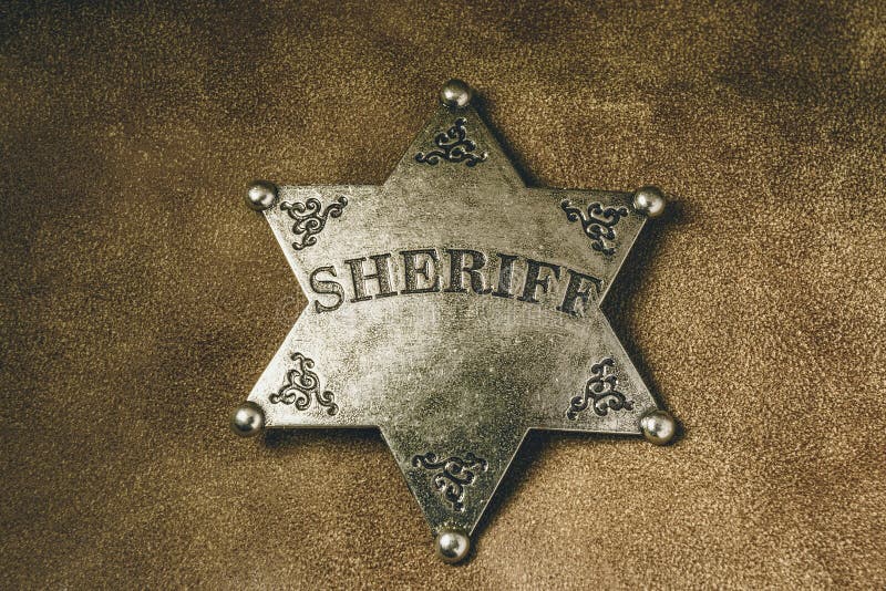 Sheriff Badge on Brown Leather Texture Background. Stock Image - Image ...