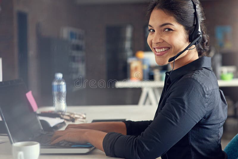 Shes Above and Beyond the Call. a Call Centre Agent Sitting at Her Desk ...