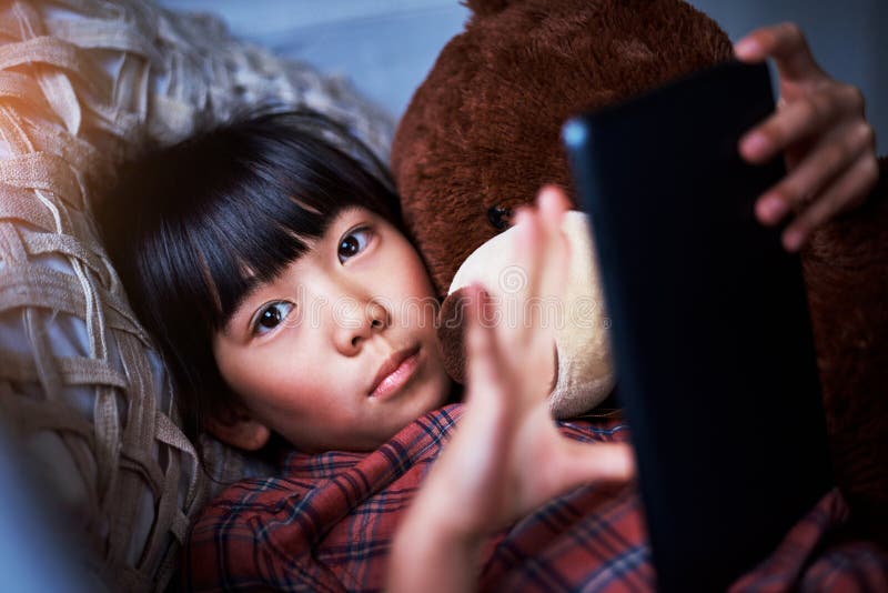 Shes a Connected Kid. a Little Girl Using a Digital Tablet at Home ...