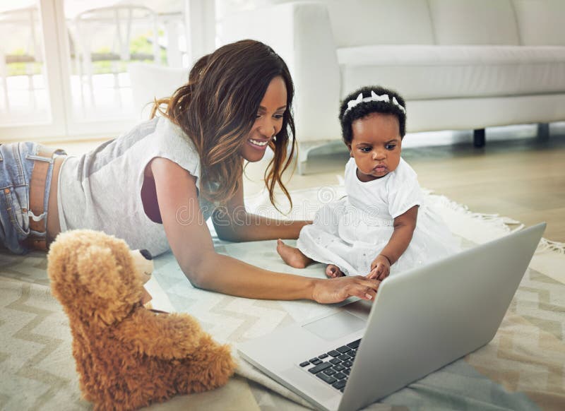 Shes a Quick Learner. a Mother Using a Laptop with and Her Baby ...