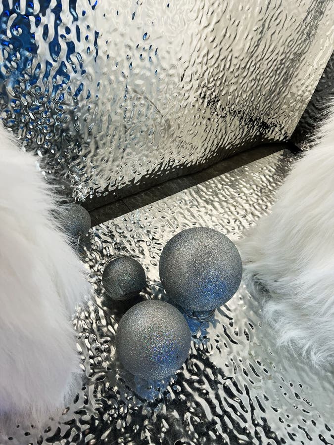 Silver Glittering Orbs on a Textured Reflective Surface with Fluffy ...