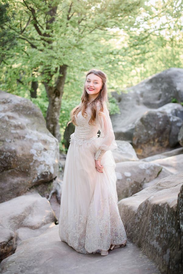 Shining Old-fashioned Bride Stands on the Rocks Stock Photo - Image of ...