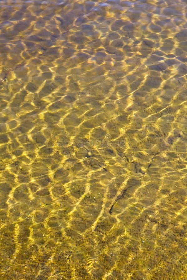 Shining Reflections of Sun Rays on Rock Bottom and Ripples on the Water ...
