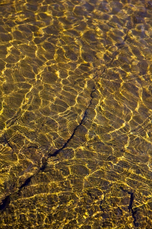 Shining Reflections of Sun Rays on Rock Bottom and Ripples on the Water ...