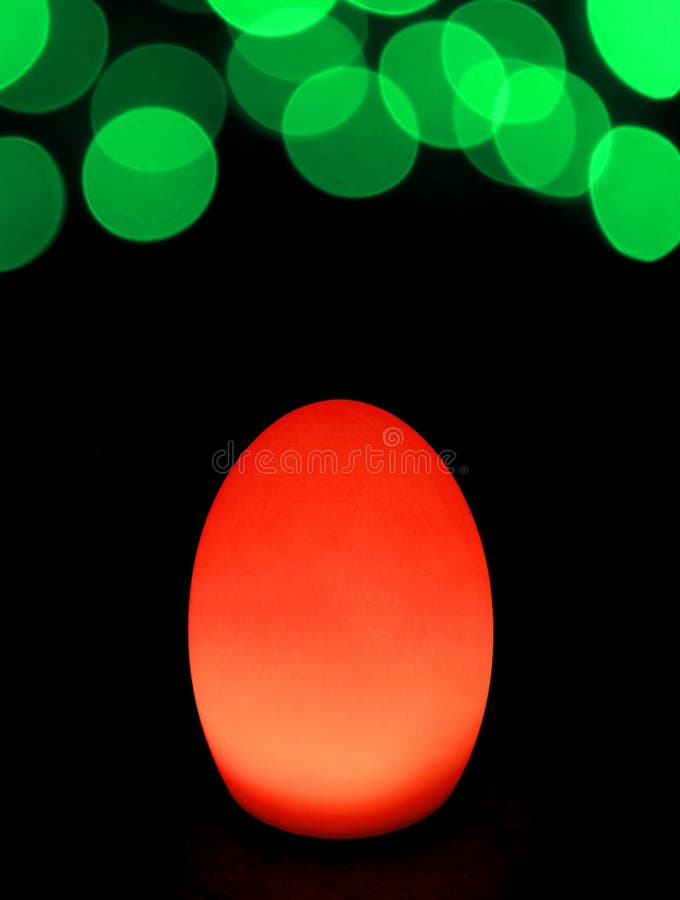 Red Egg Shaped Table Lamp with Vivid Green Bokeh Light on Dark ...