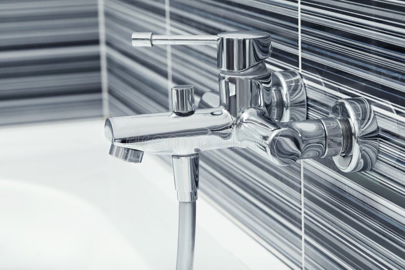 Shiny Bath Water Tap Installed on Black and White Wall Stock Photo ...