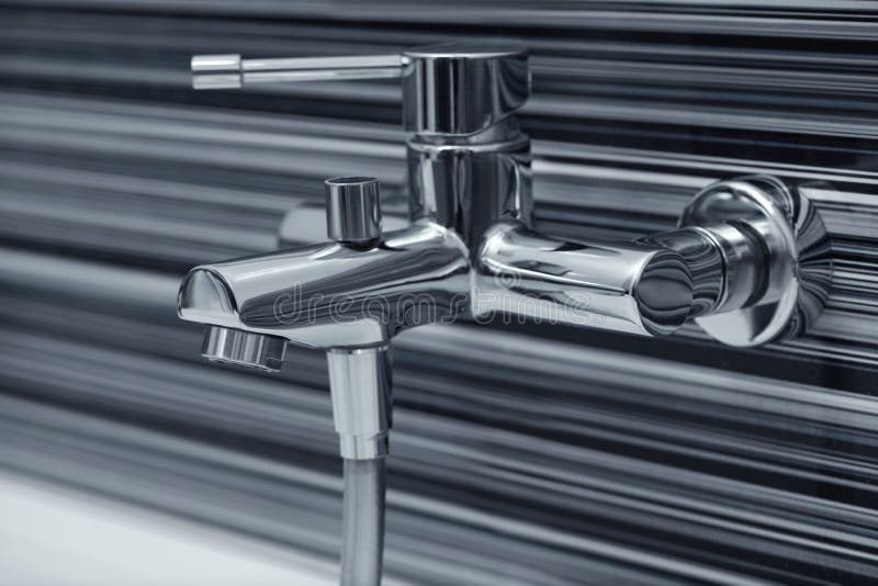 Shiny Bath Water Tap Installed on Black and White Wall Stock Image ...