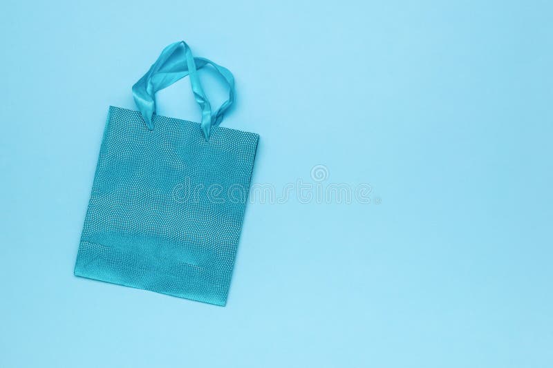 A Shiny Blue Gift Bag on a Blue Background Stock Image - Image of light ...
