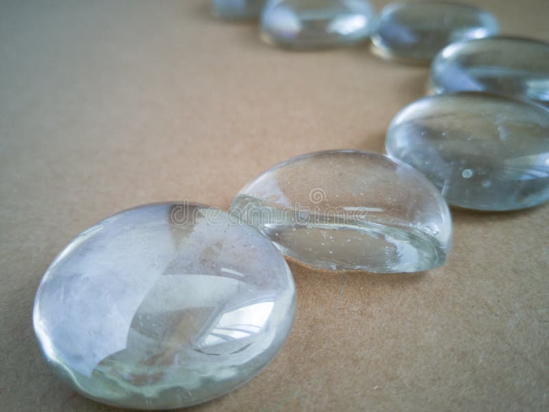Clear Marbles with Light Reflections on a Brown Background. Stock Image ...