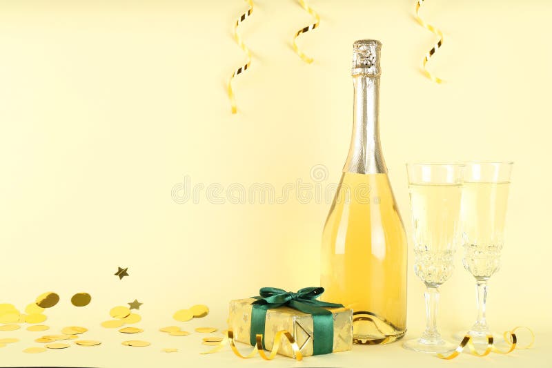 Shiny Confetti, Streamers, Sparkling Wine and Gift Box on Beige ...