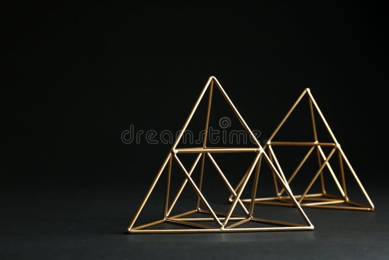 Shiny Decorative Gold Pyramids on Black Background Stock Image - Image ...