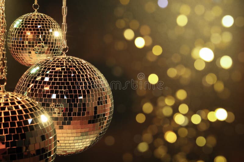 Shiny Disco Balls Under Yellow Light, Space for Text Stock Photo ...
