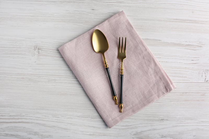 Shiny Fork, Spoon and Napkin on Wooden Table, Top View Stock Image ...