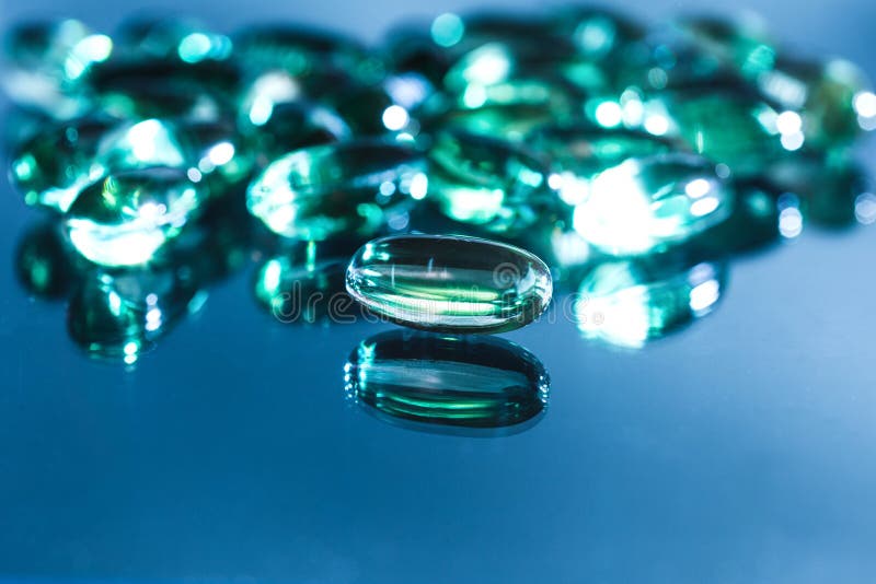 Clear Gel Capsules on Blue Background Stock Image - Image of illness ...