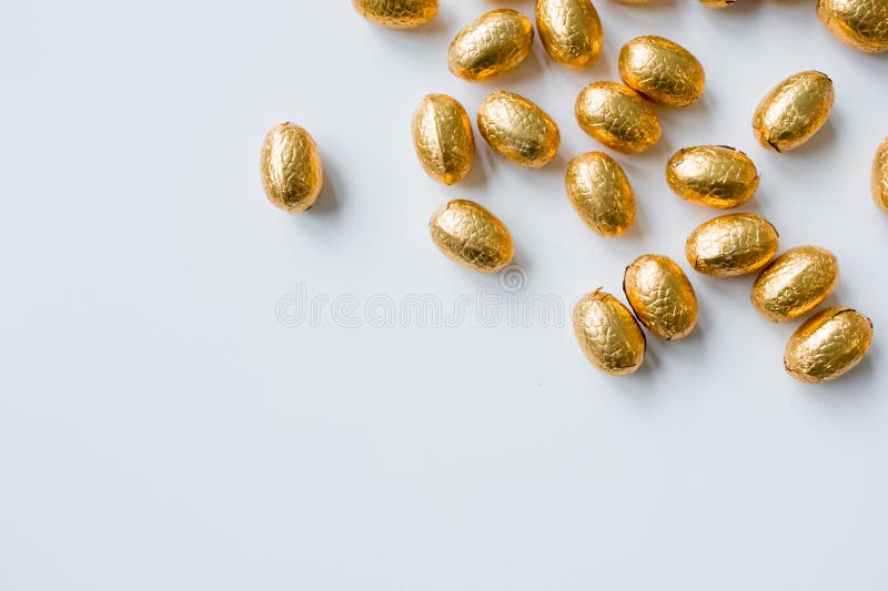 Shiny Gold Foil Wrapped Chocolate Eggs on White Background Stock Image ...